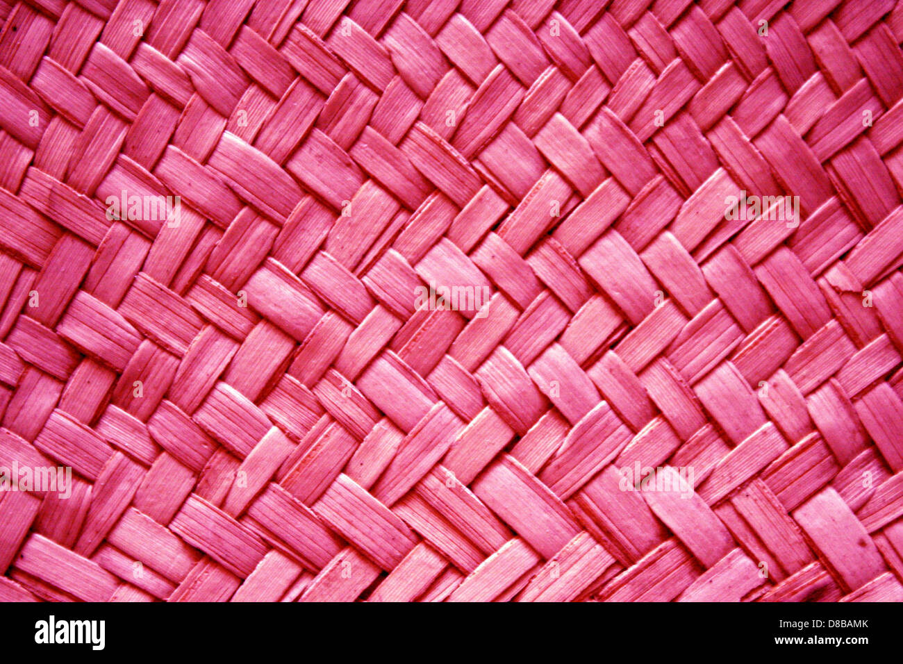 This image features a woven straw texture in a bright pink color ...