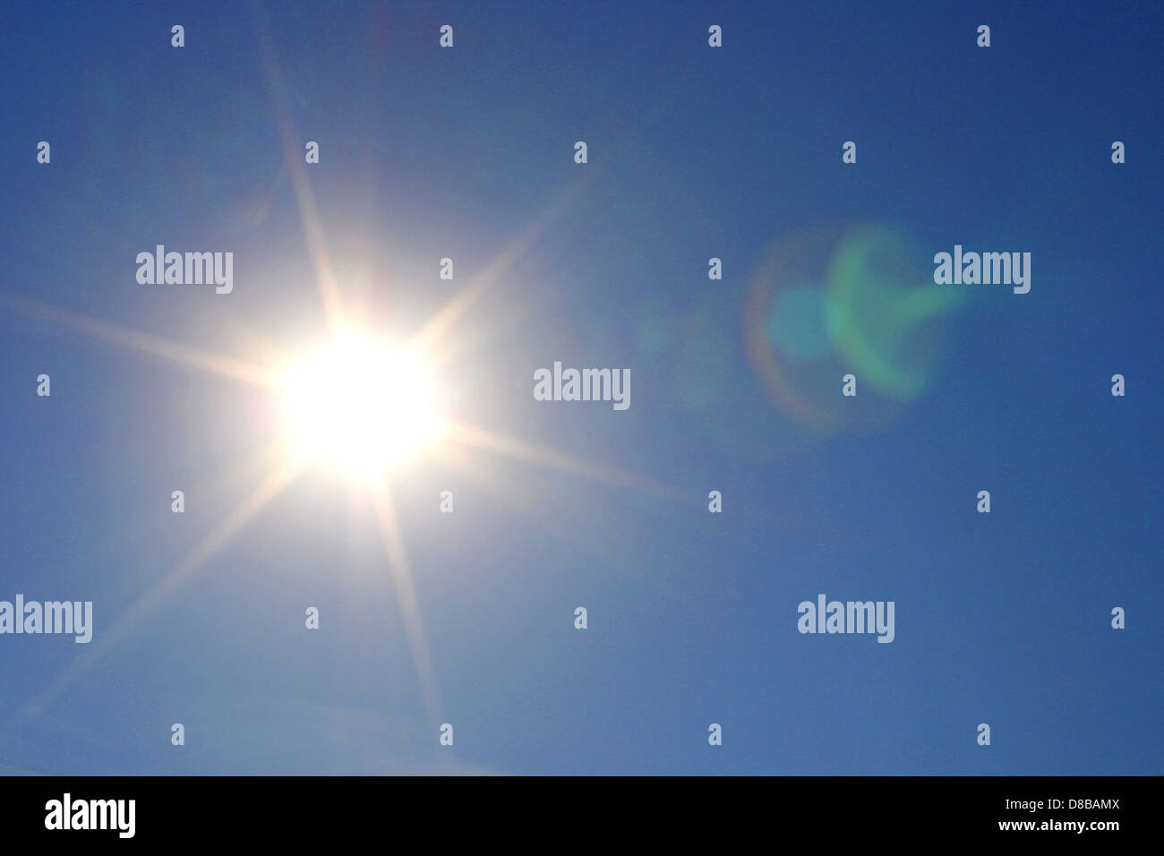 A clear sky with a bright sun shining down. The image captures the ...