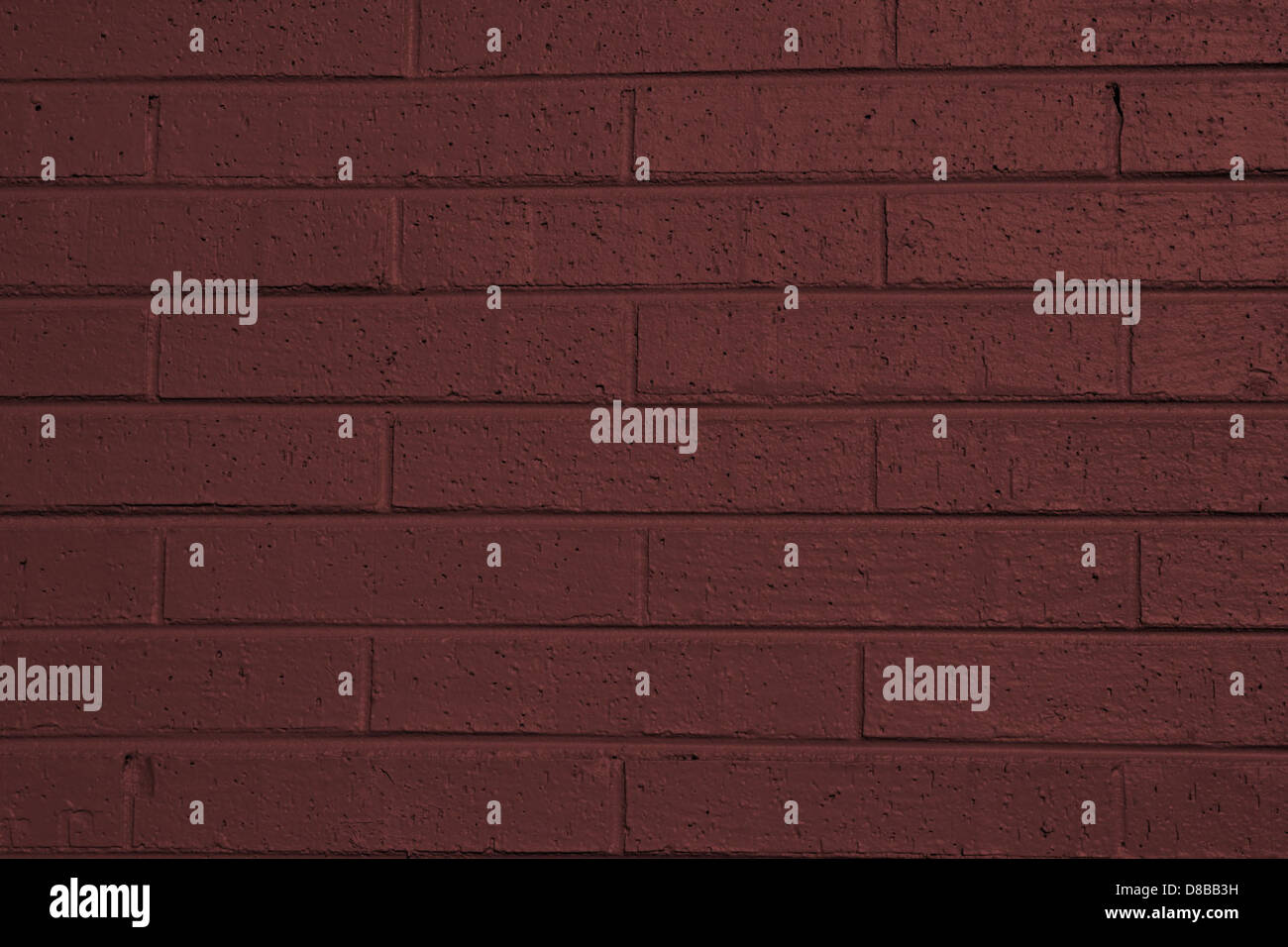 A textured image of a brownish-red painted brick wall, featuring a ...