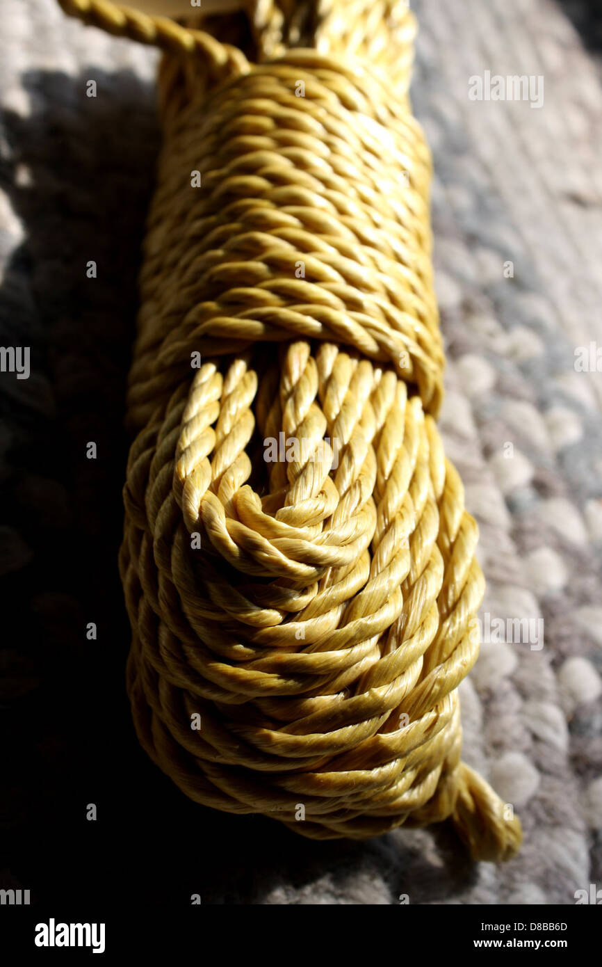 A bundle of bright yellow nylon rope neatly coiled, used in a variety ...