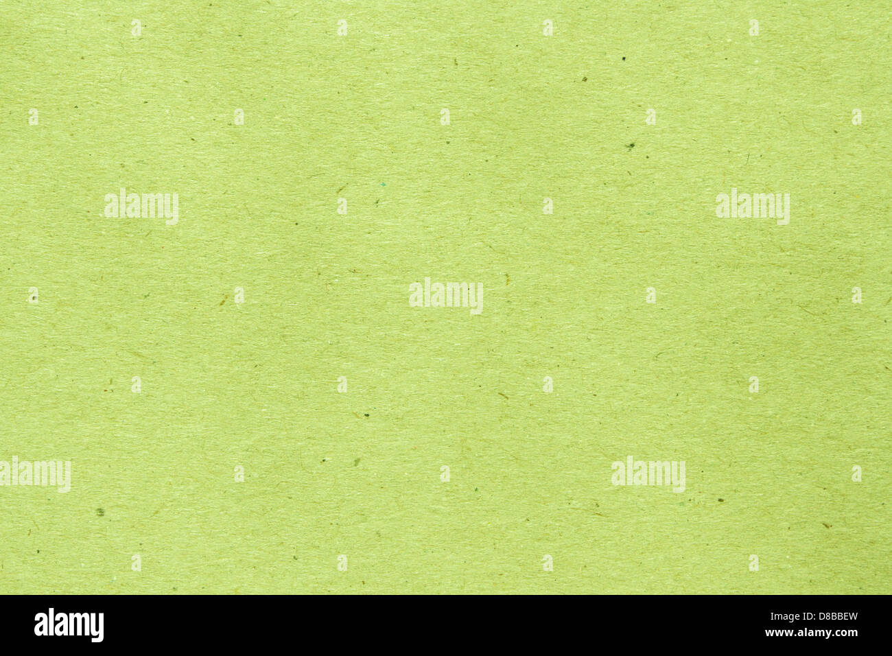 A close-up of chartreuse paper with small flecks embedded in the ...