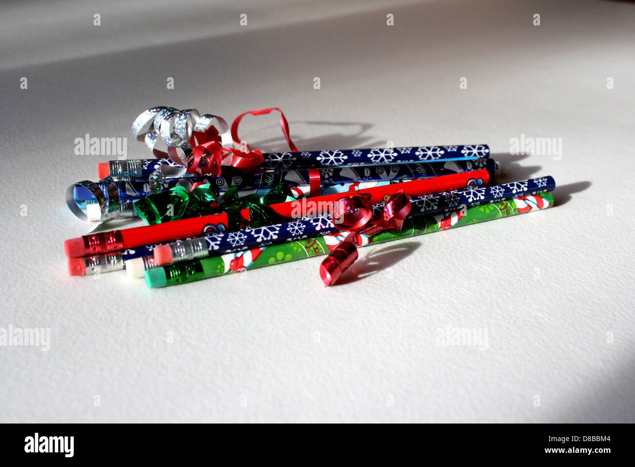 A set of Christmas-themed pencils decorated with festive designs like ...