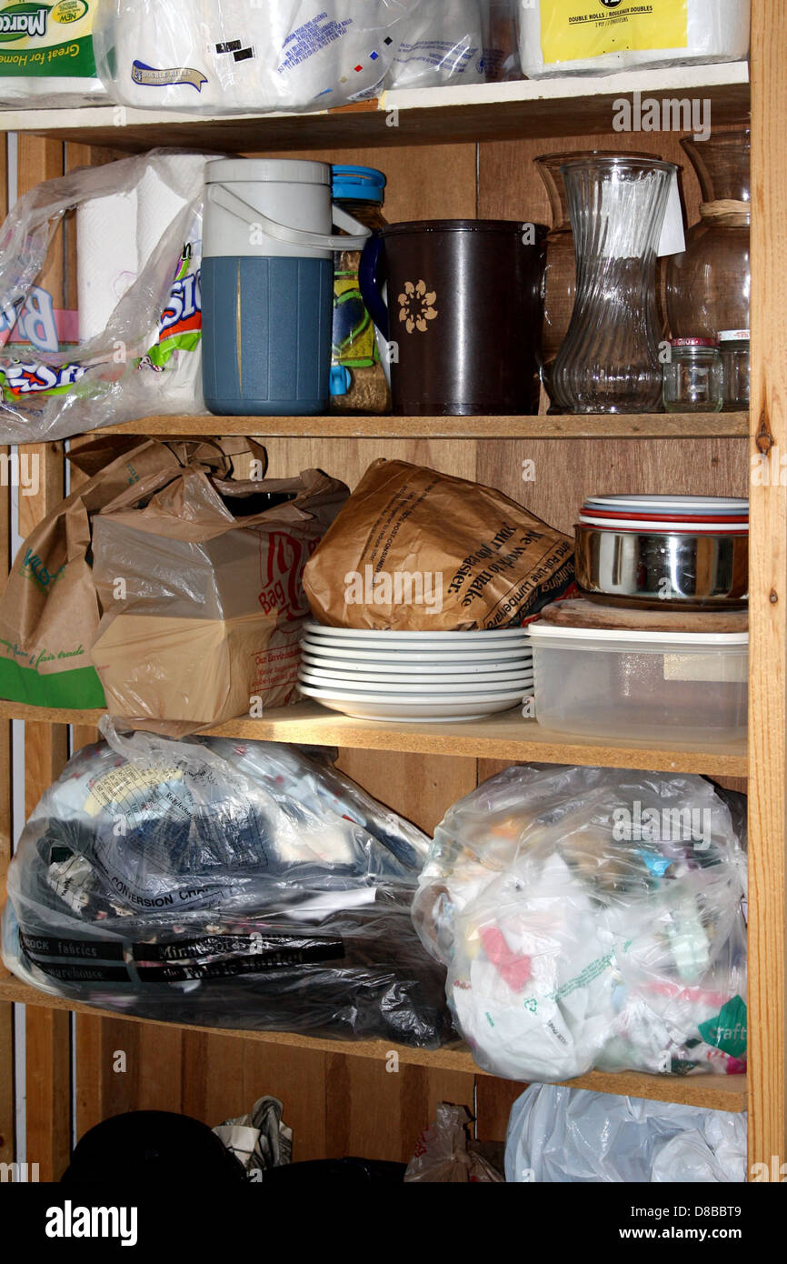 This image shows a set of cluttered storage shelves filled with various ...