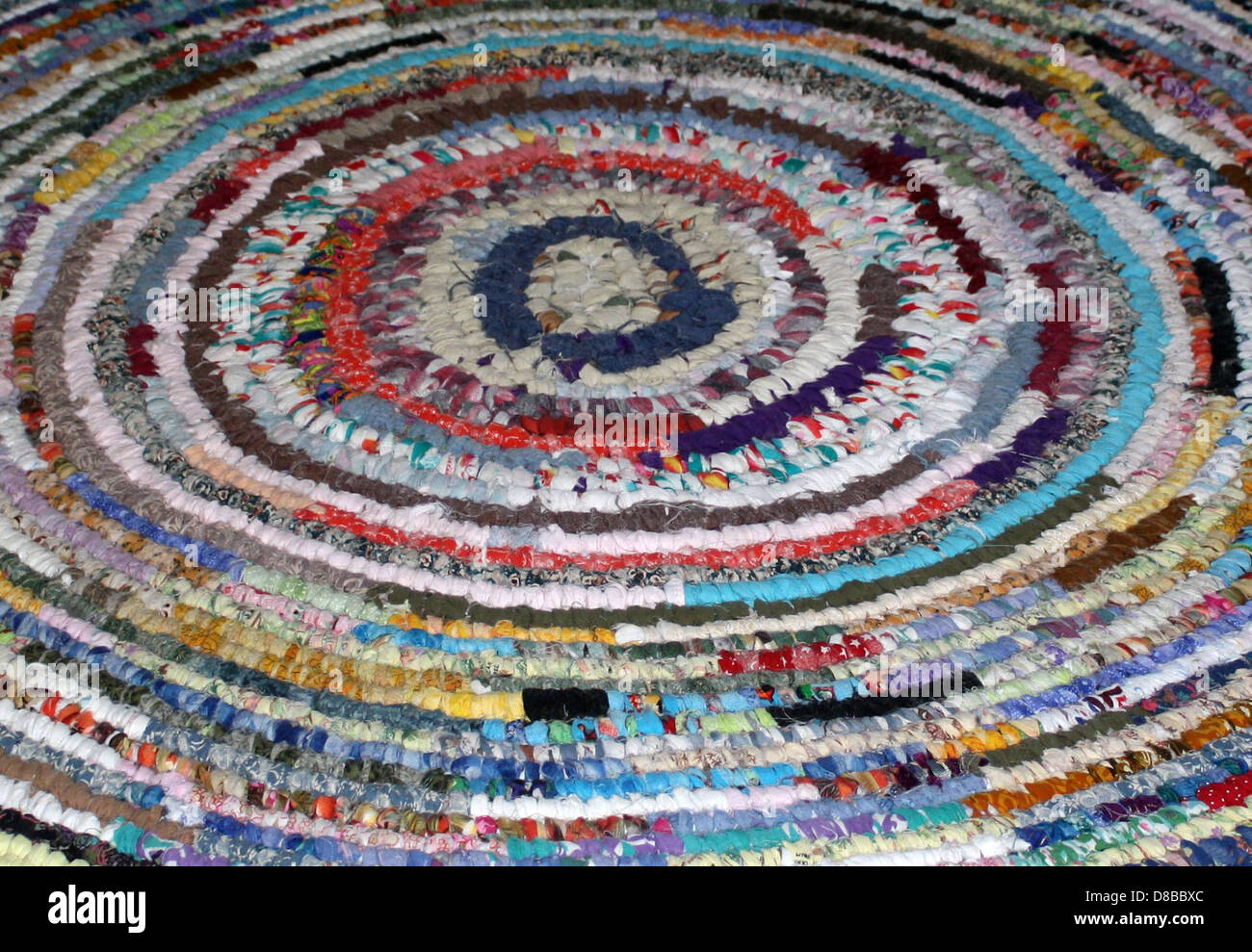 A close-up image of a colorful rag rug, showcasing the woven textures ...