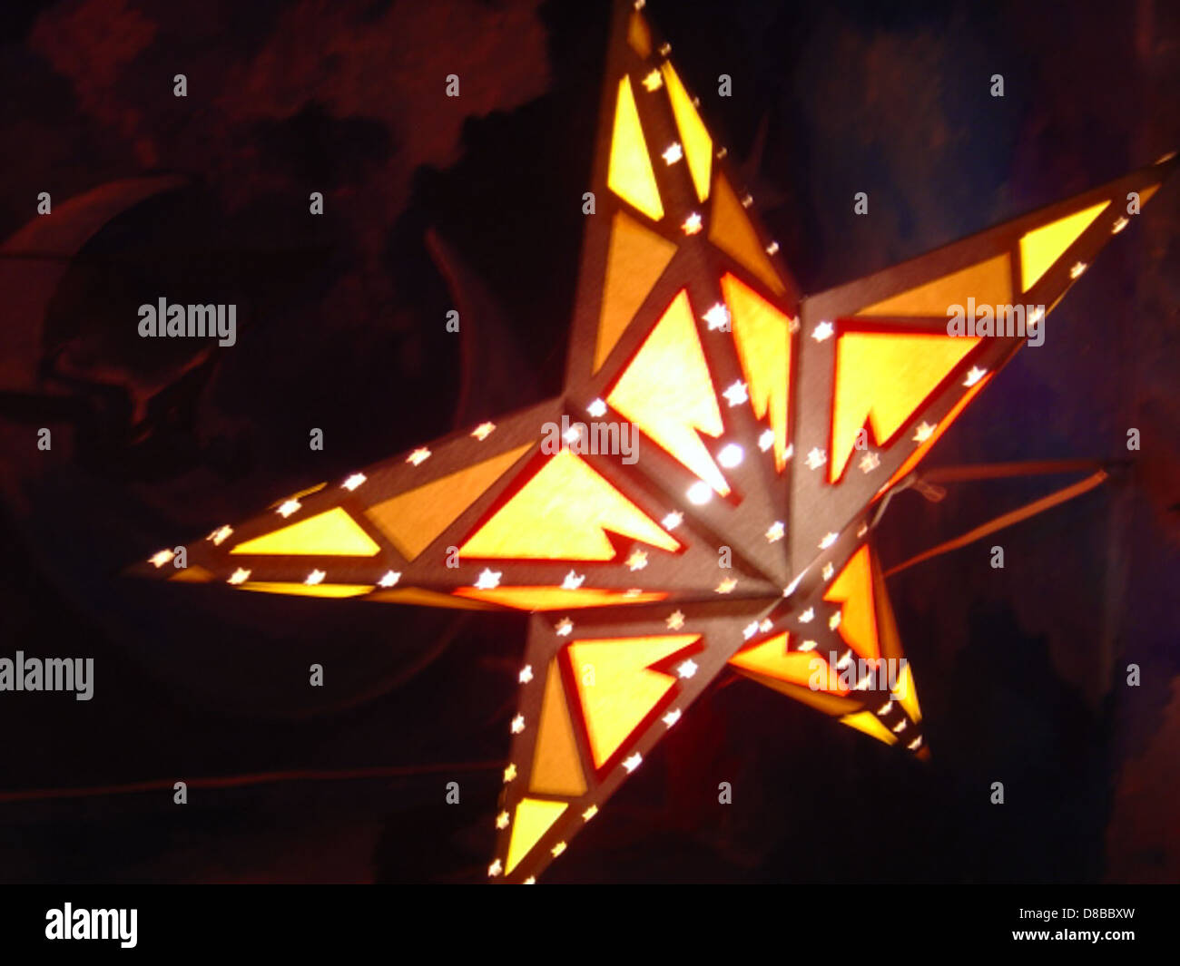 A colorful star-shaped lamp creates a vibrant, decorative lighting ...