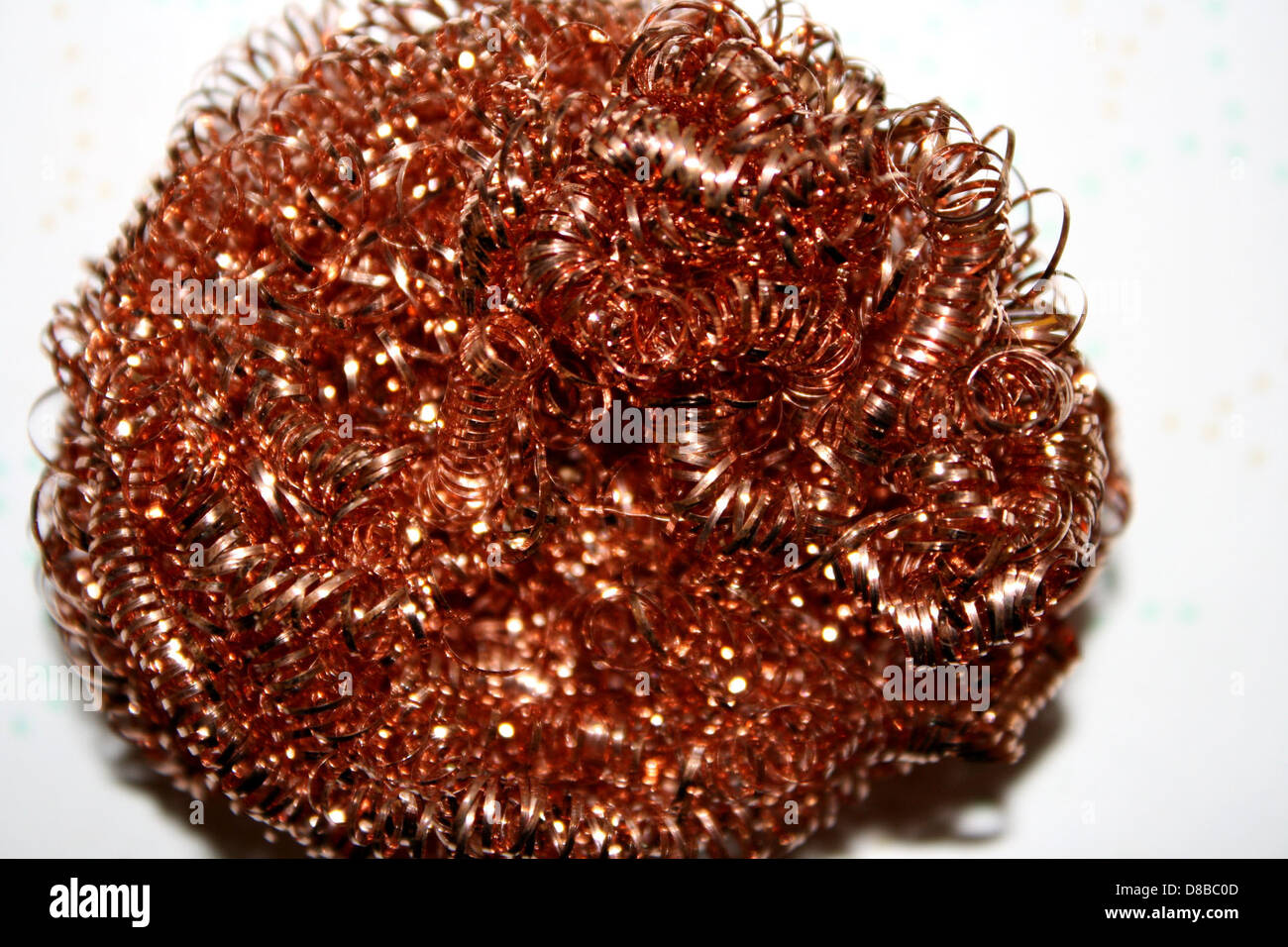 A close-up view of a copper pot scrubber, highlighting its metallic ...