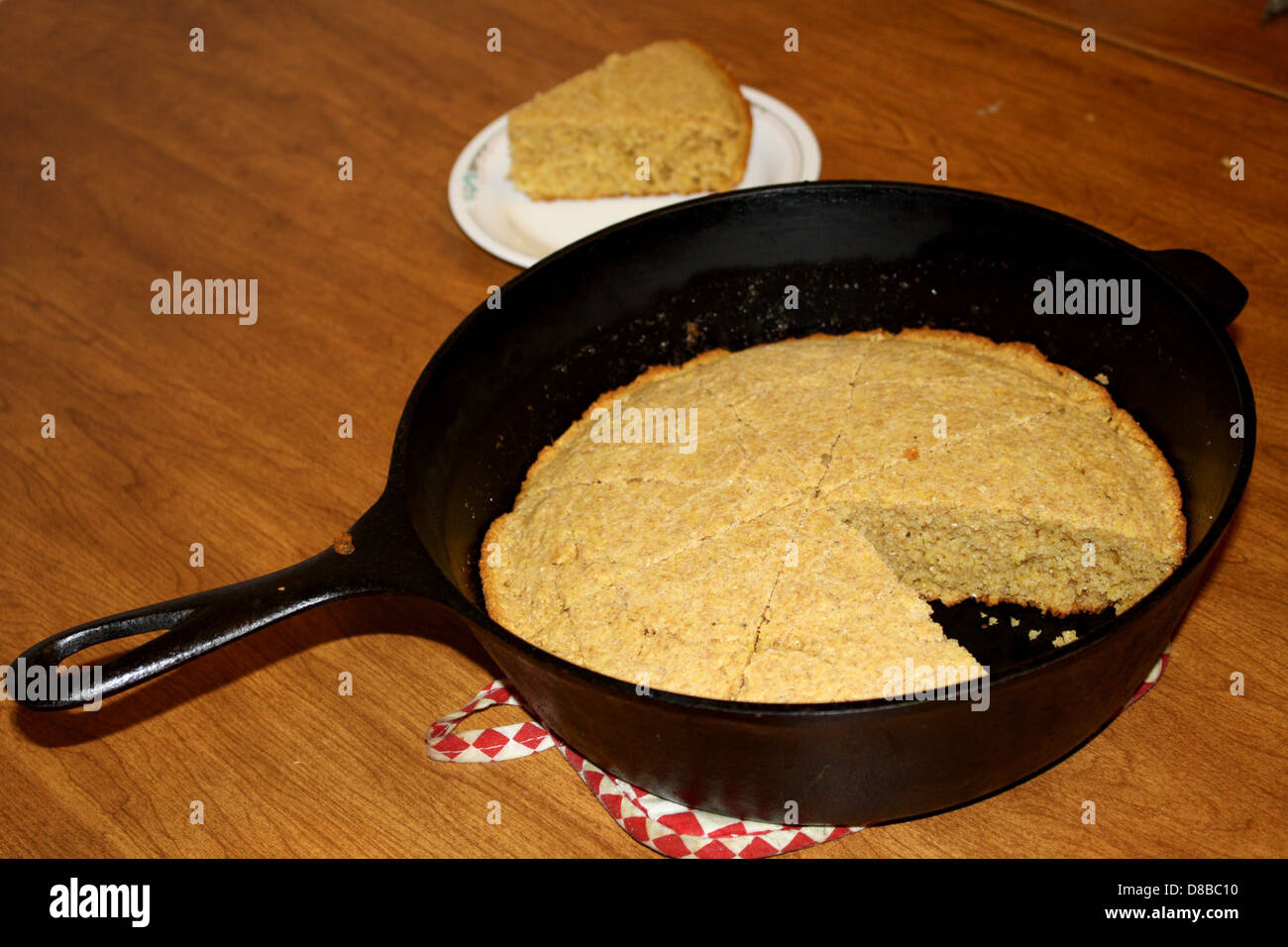 A freshly baked cornbread served in a cast iron Dutch oven ...