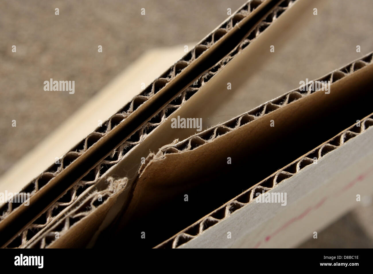 A close-up of corrugated cardboard, emphasizing its ridged structure ...