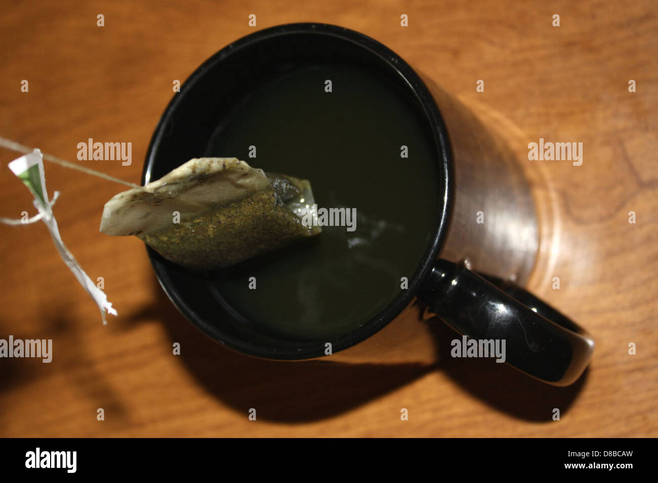 A cup of freshly brewed tea with a tea bag still submerged in the hot ...
