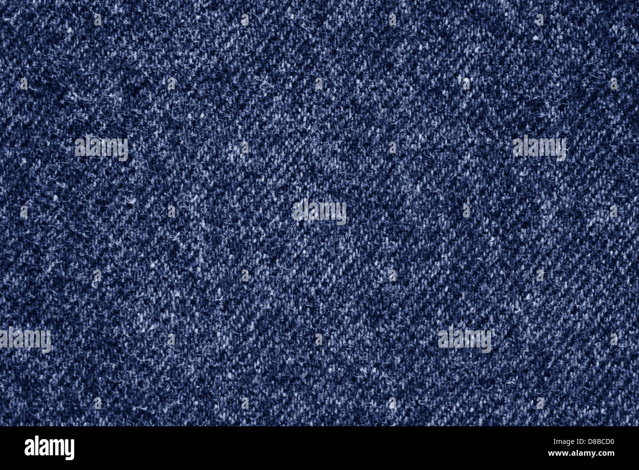A close-up view of dark blue denim fabric, showing its classic woven ...