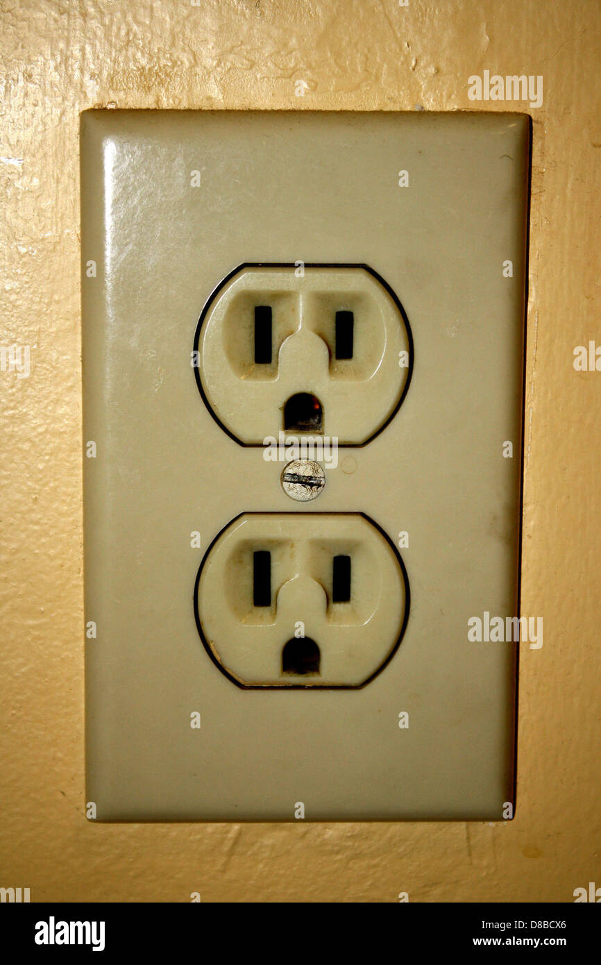 A close-up of a standard electrical outlet. The image shows the two ...