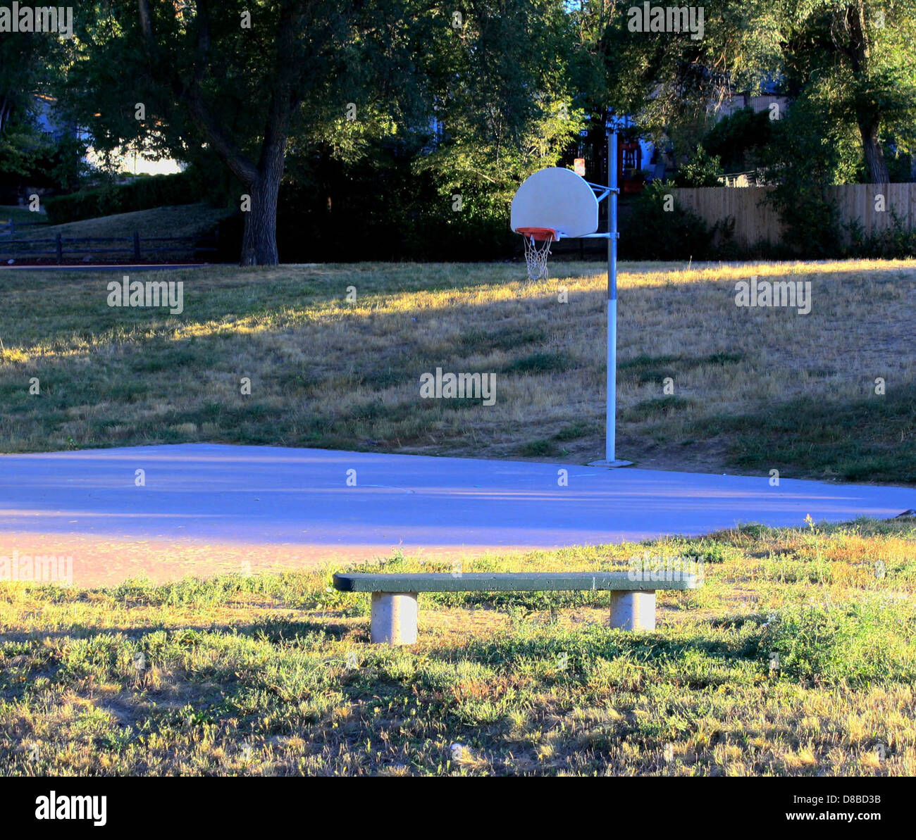 An empty bench at a basketball court, emphasizing a quiet moment in an ...