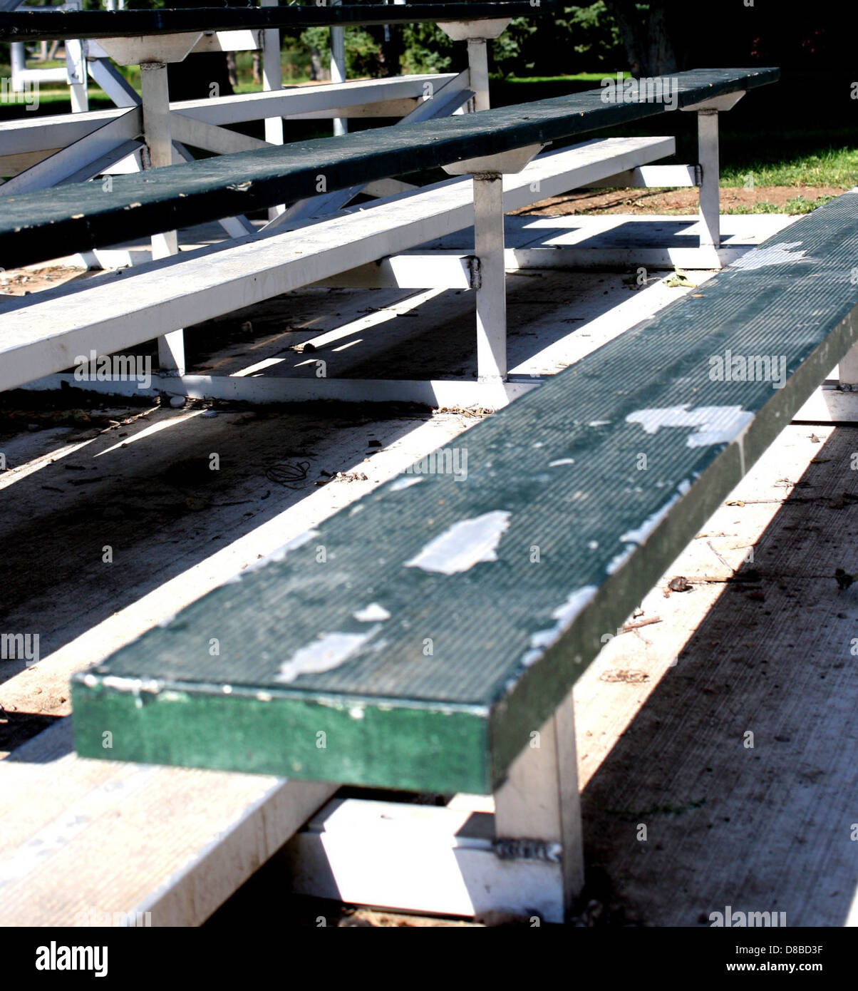 Empty bleachers in a park, typically used for watching sports events or ...