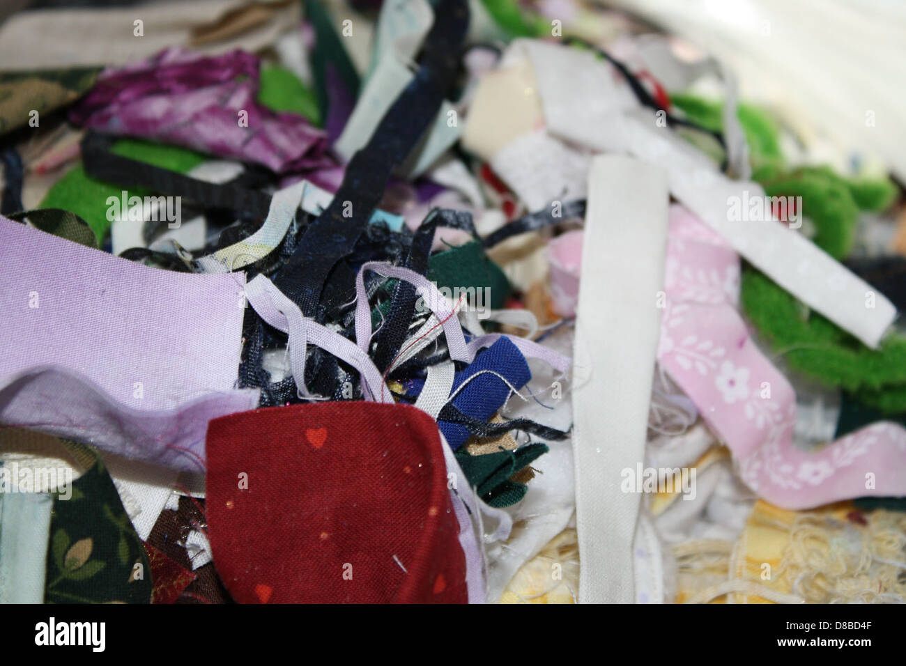 A collection of fabric scraps in various colors and textures, ideal for ...