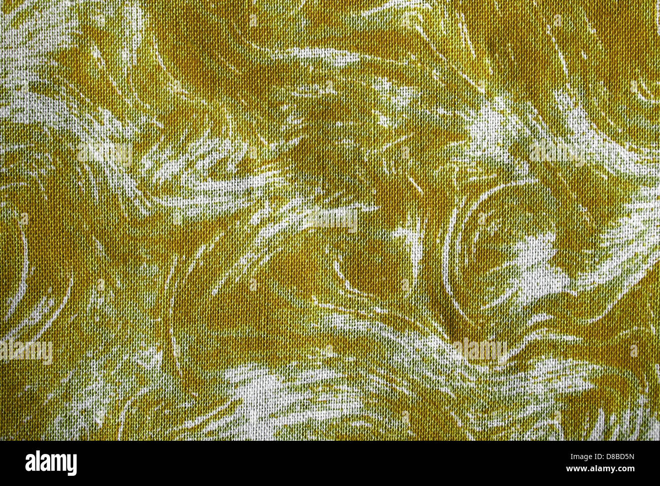 A fabric with a golden swirl pattern offers a luxurious and decorative ...
