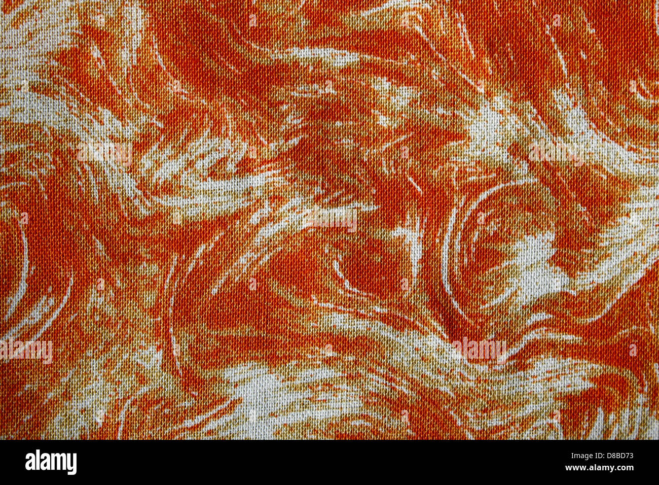 The fabric features an orange swirl pattern, created through dyeing or ...