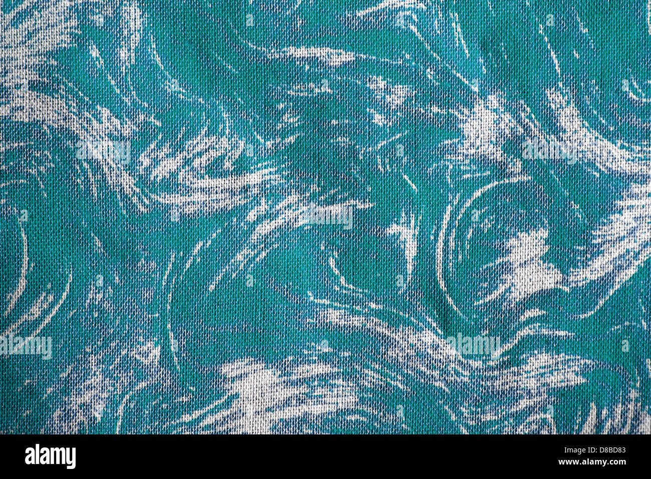 A fabric featuring a teal swirl pattern, showcasing the smooth texture ...