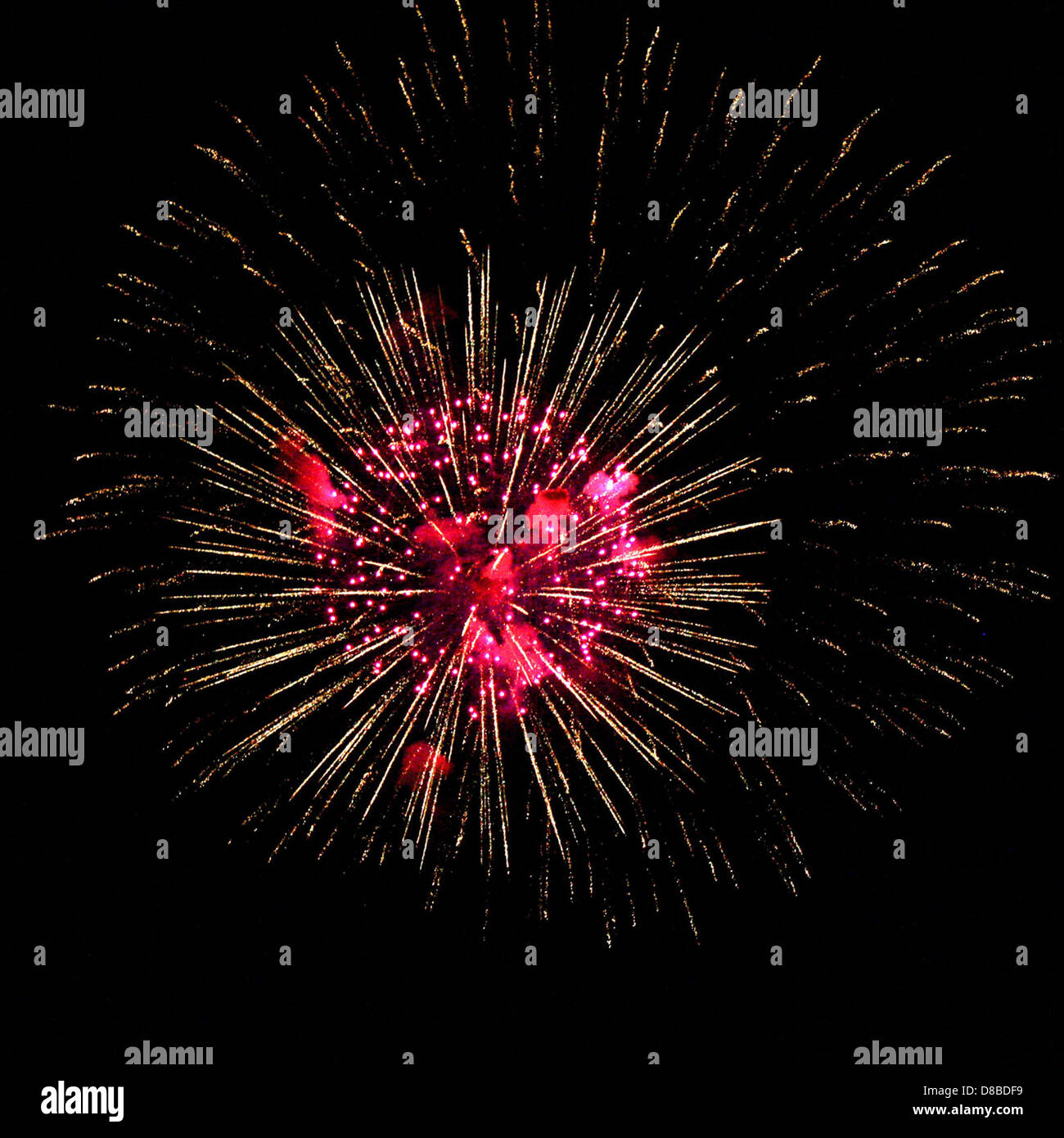 A vibrant display of fireworks exploding in a starburst pattern, with ...