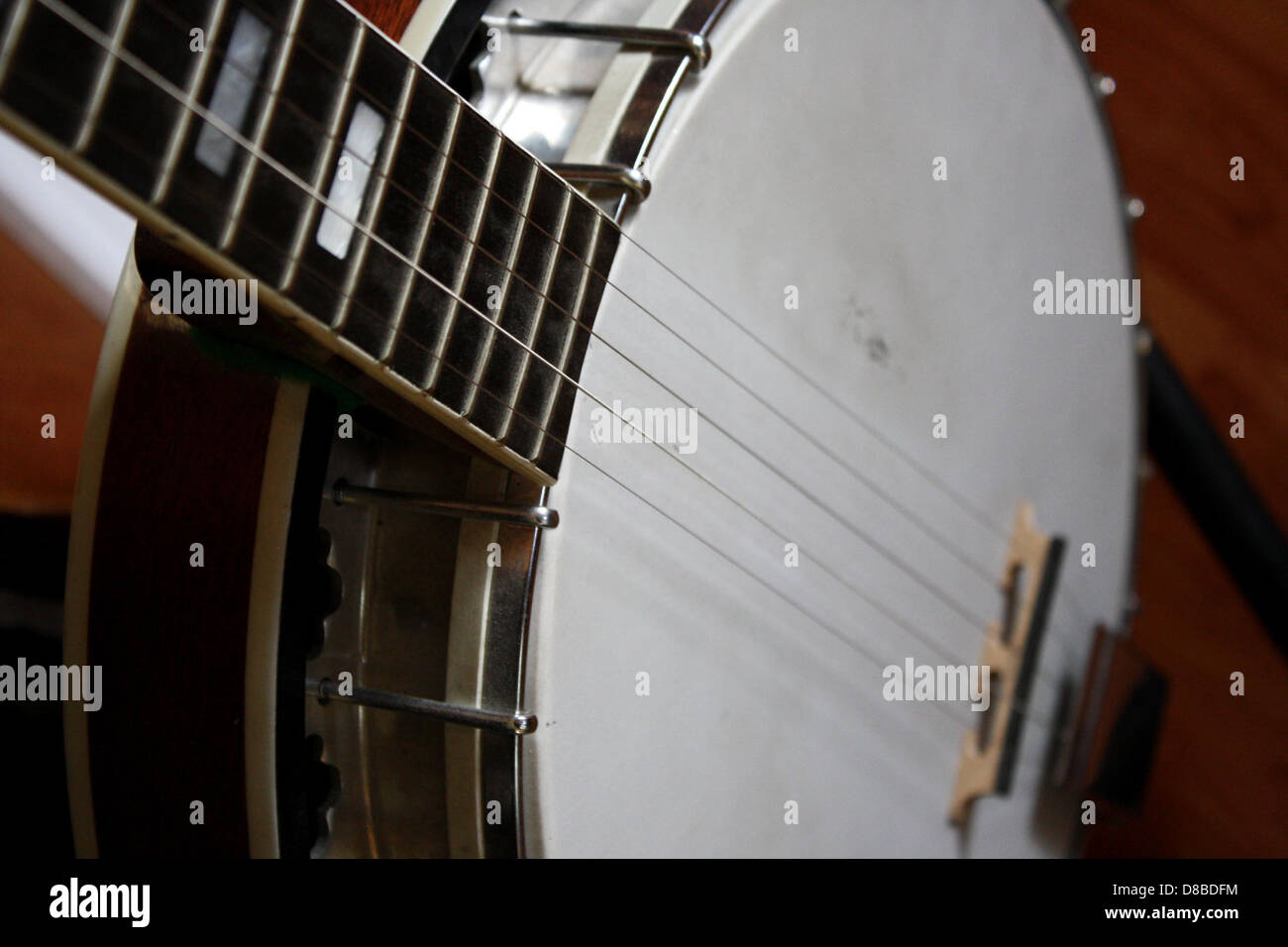 A close-up shot of a five-string banjo, highlighting the details of its ...