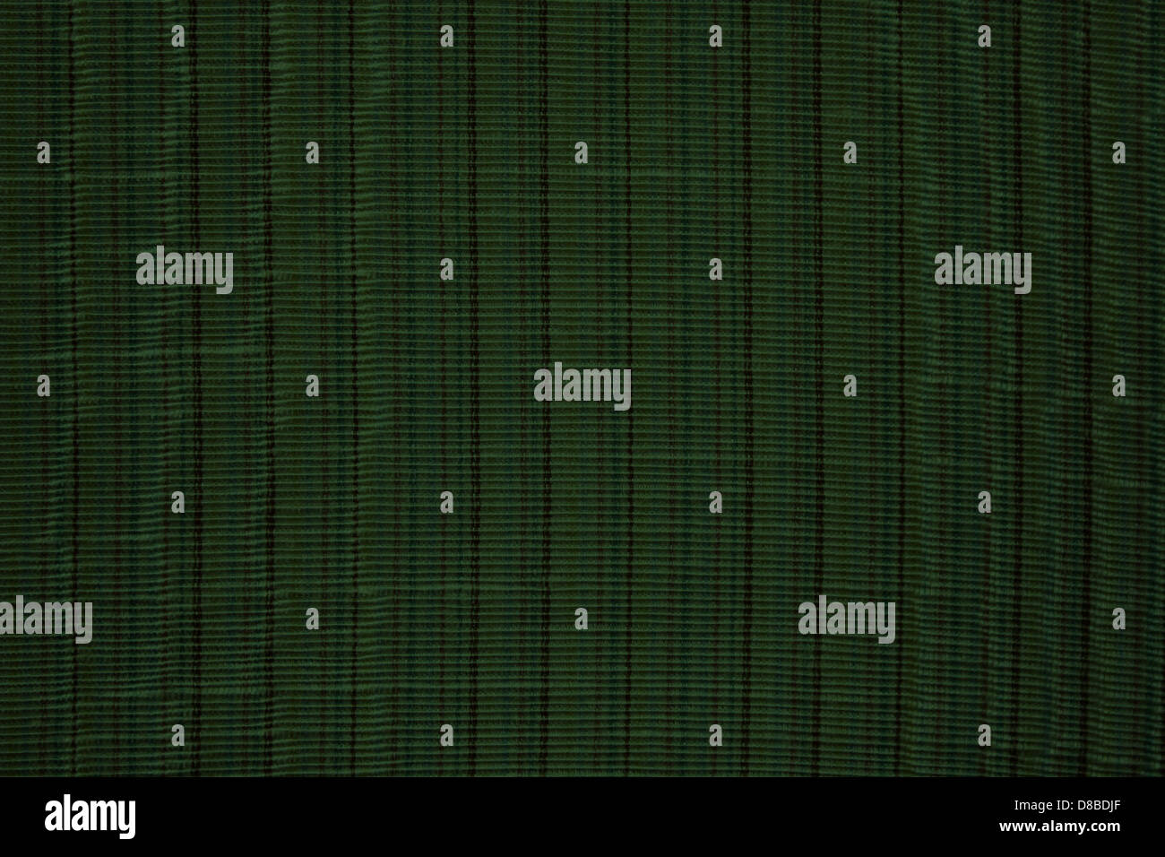 A close-up of forest green upholstery fabric with distinct stripes. The ...