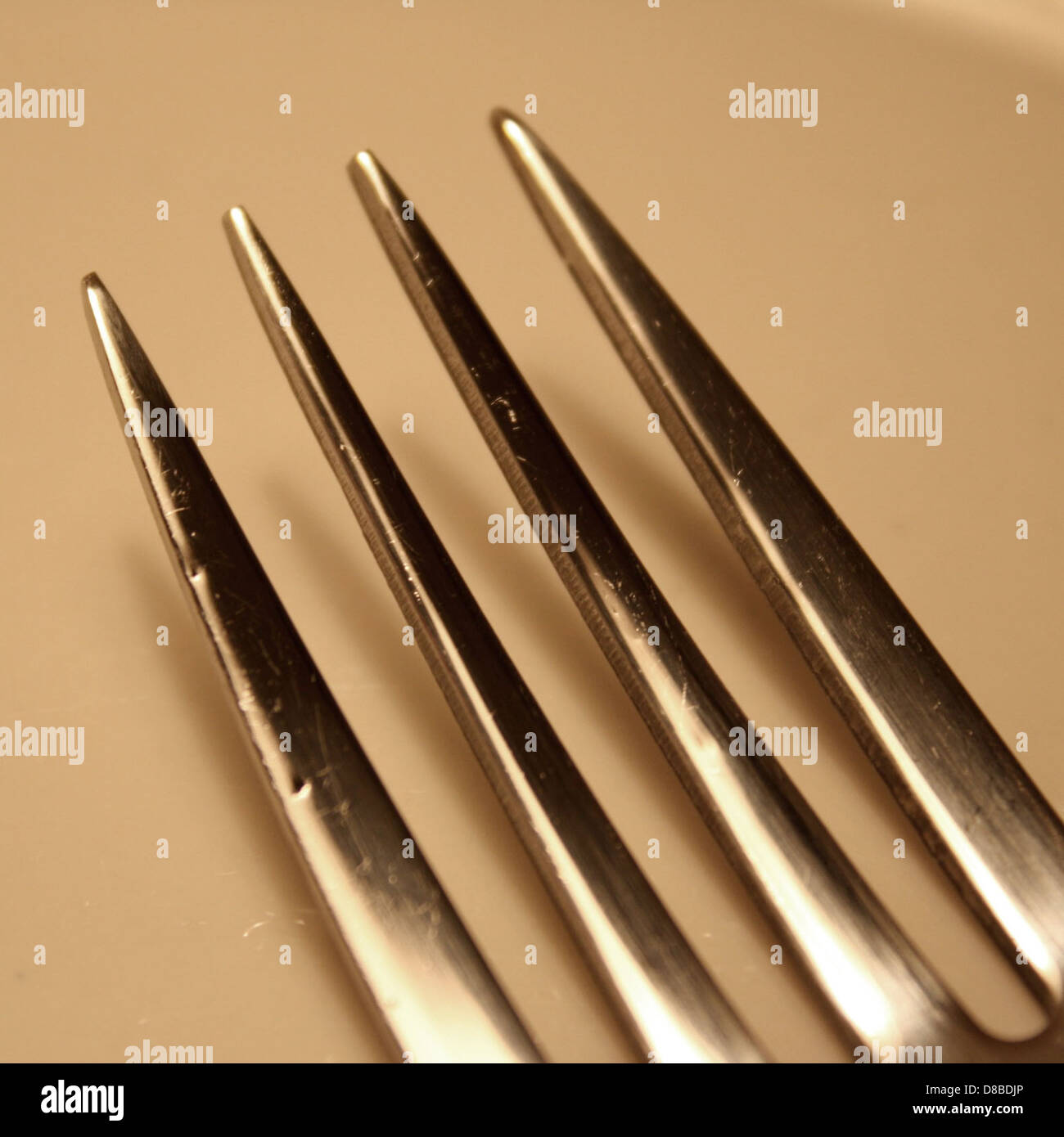 A close-up of the prongs or tines of a fork, showcasing the metallic texture and design. Forks ...