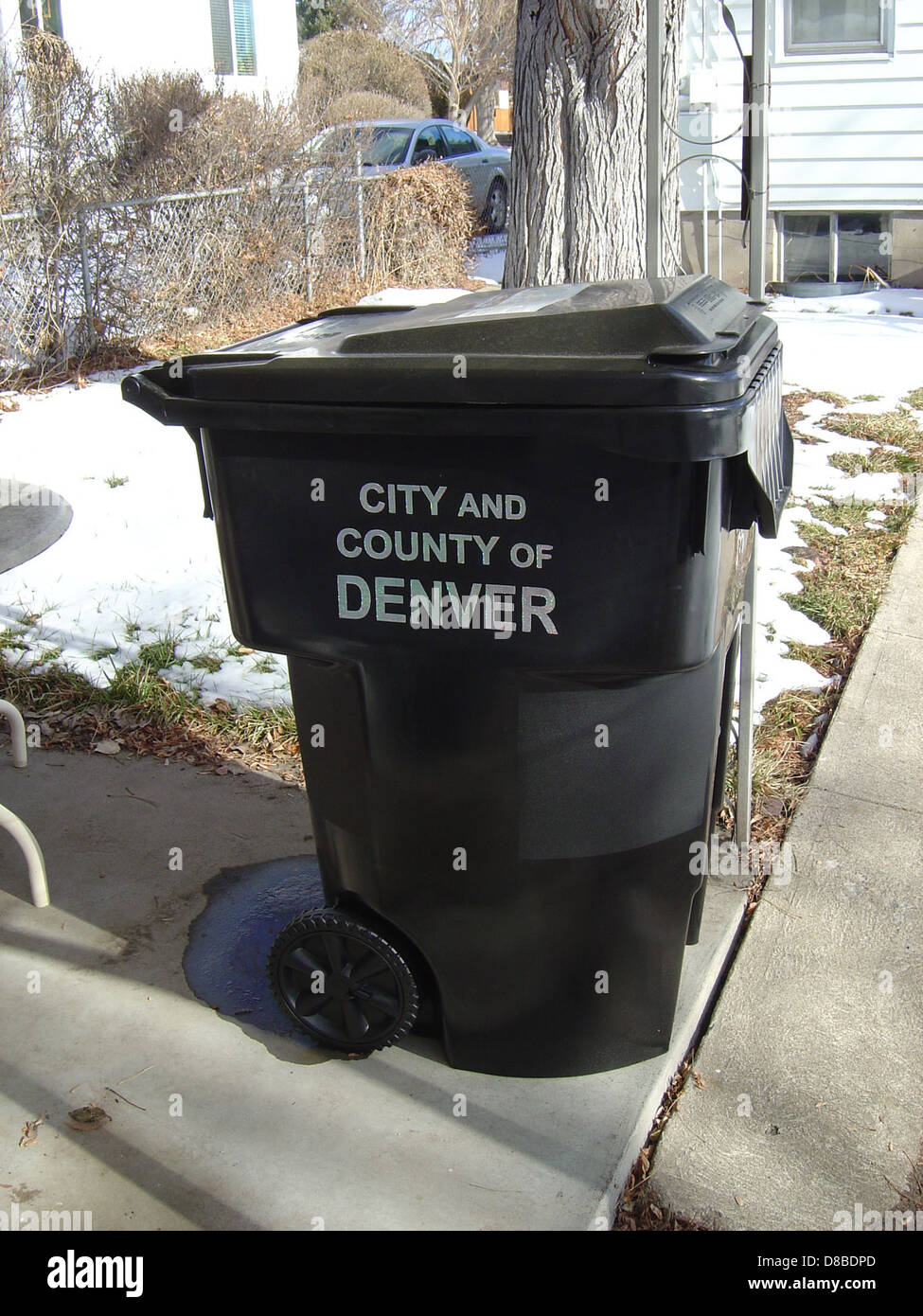 This image features a standard garbage can, often used for waste ...