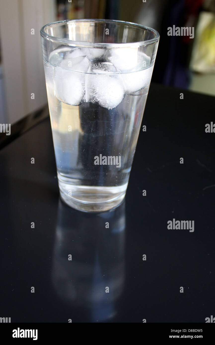 Glass filled water sits on hi-res stock photography and images - Alamy