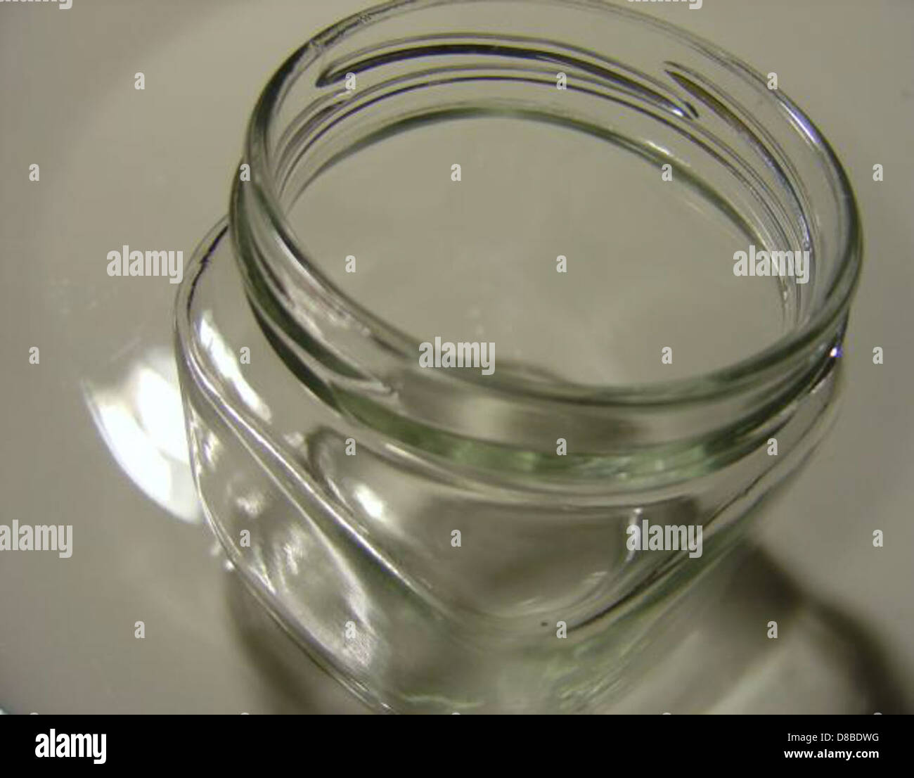 A simple glass jar placed against a neutral background. The ...