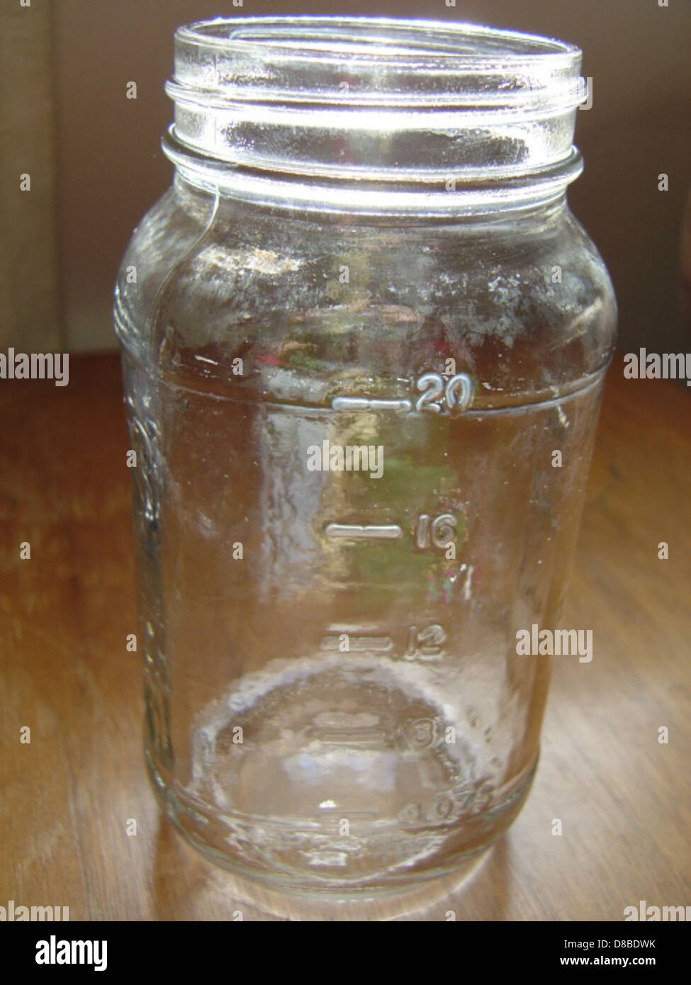 A clear glass mason jar is shown, commonly used for storing food ...