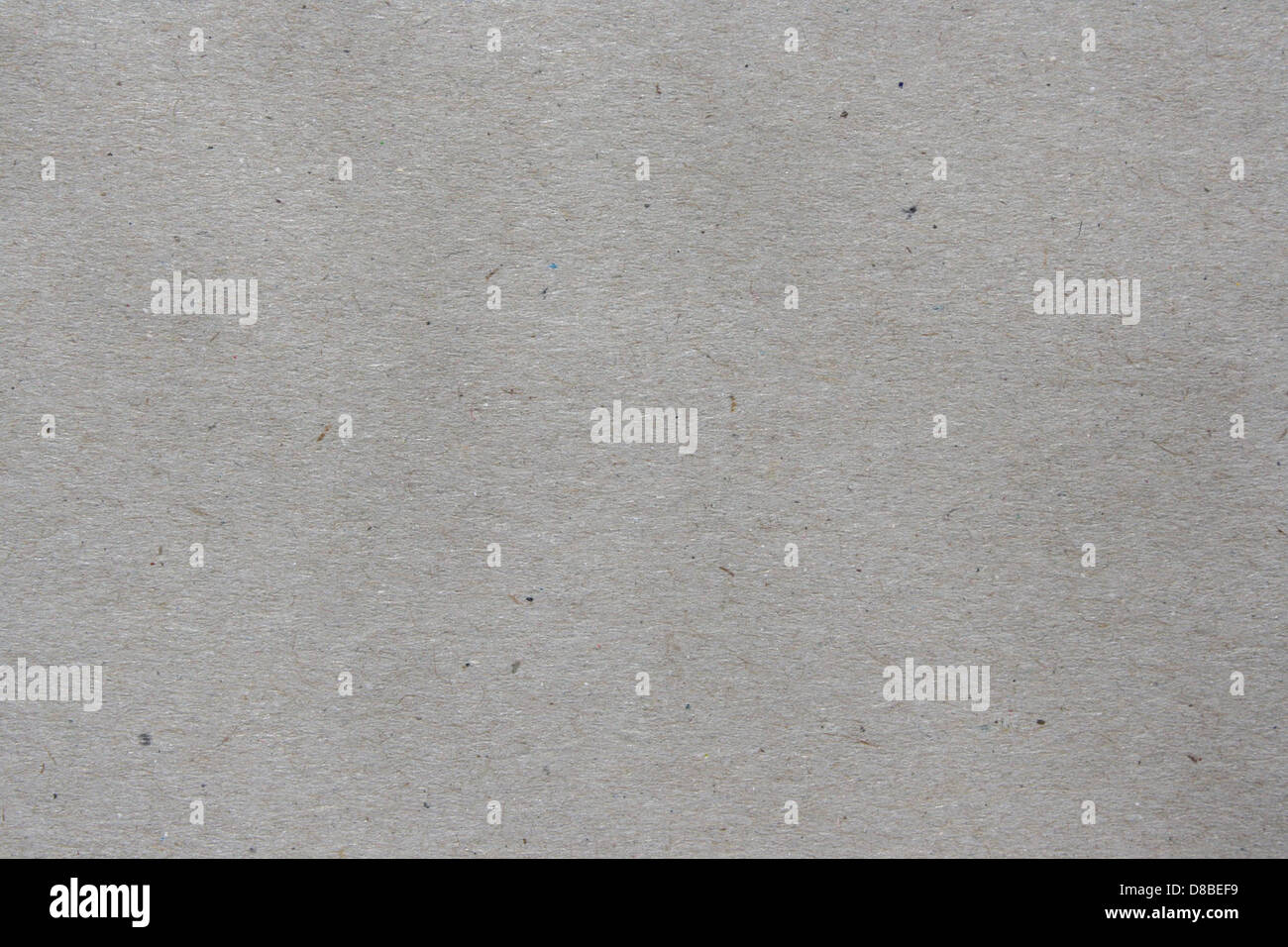 This image displays the texture of gray recycled paper, with visible ...