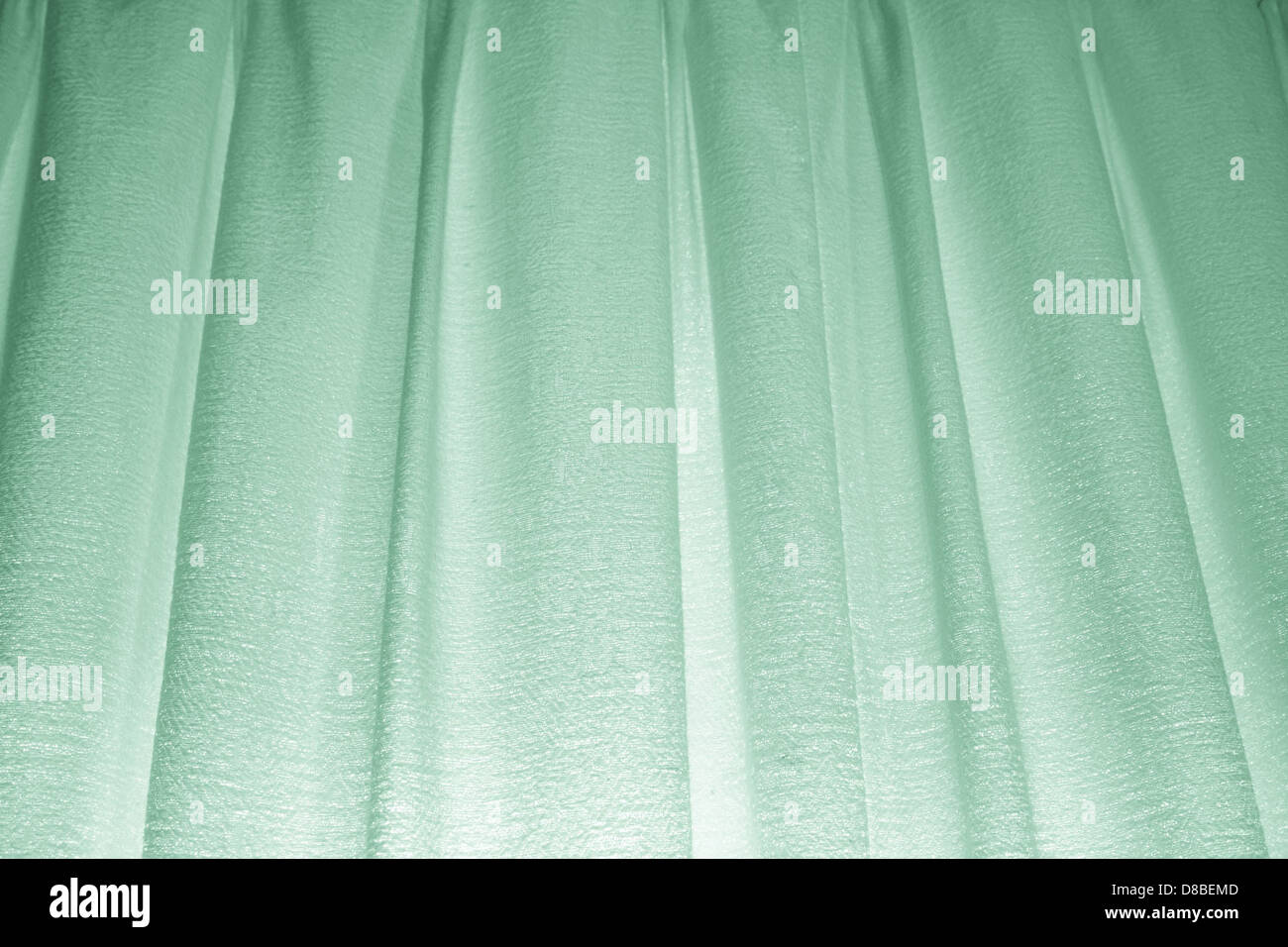 This image shows a close-up of green curtains, showcasing the texture ...