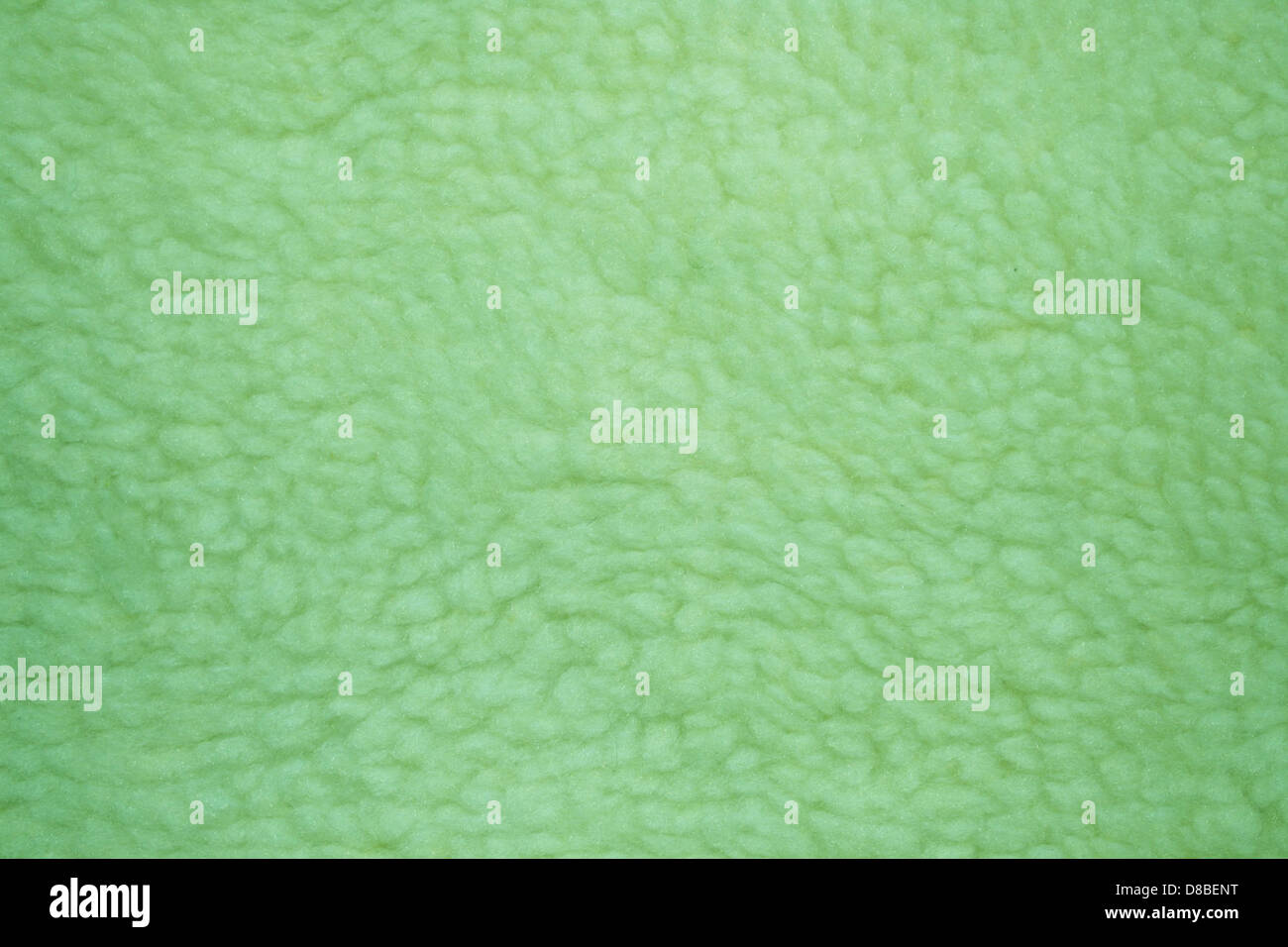 A close-up image of green fleece faux Sherpa wool fabric, showing its ...