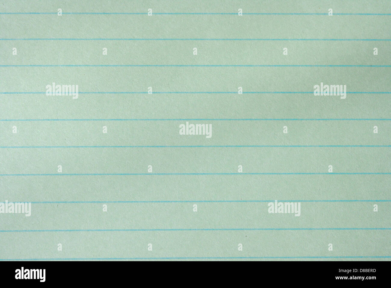 A close-up image of green notebook paper, highlighting its texture and ...