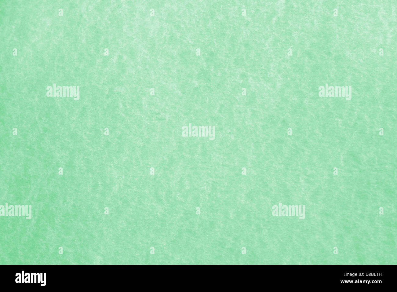 This stock photo shows a textured green parchment paper, with subtle ...