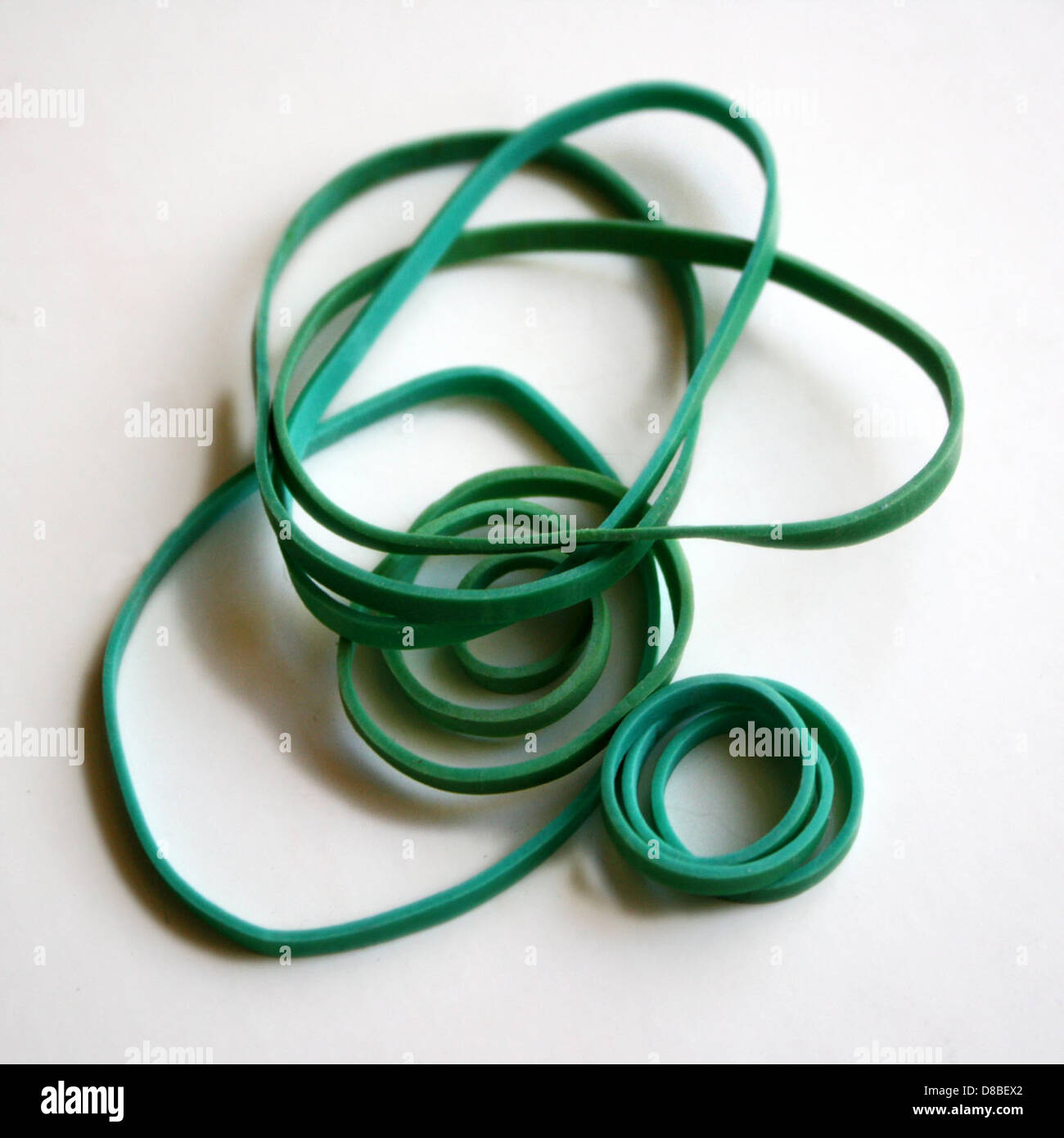 A collection of green rubber bands stacked together, showing their ...