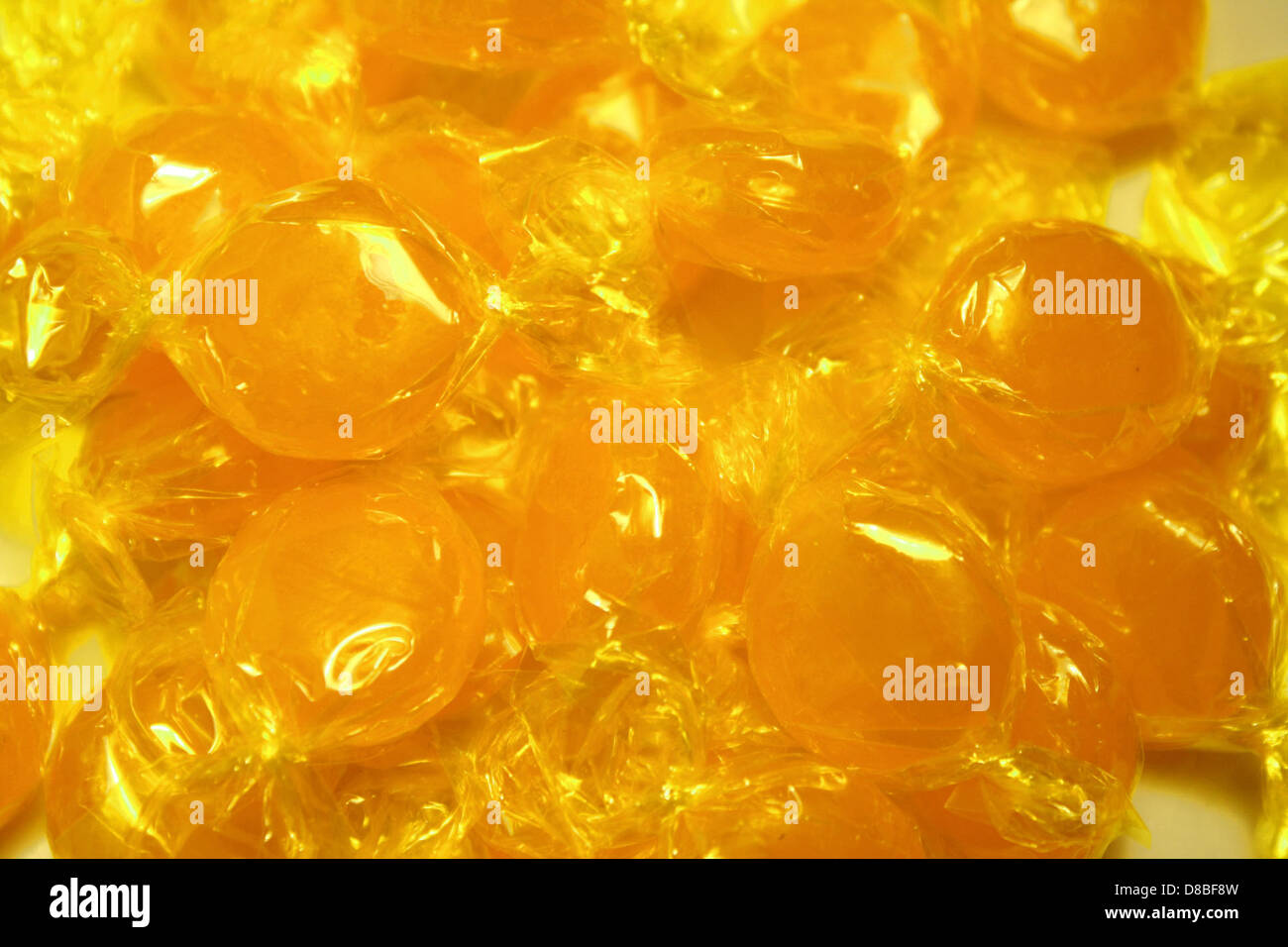 A close-up of hard butterscotch candy, showcasing its golden-brown ...