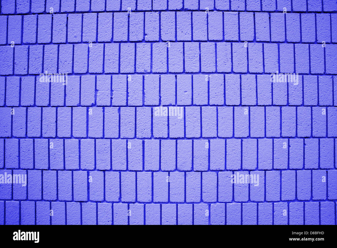 A close-up view of an indigo blue brick wall with vertical bricks ...