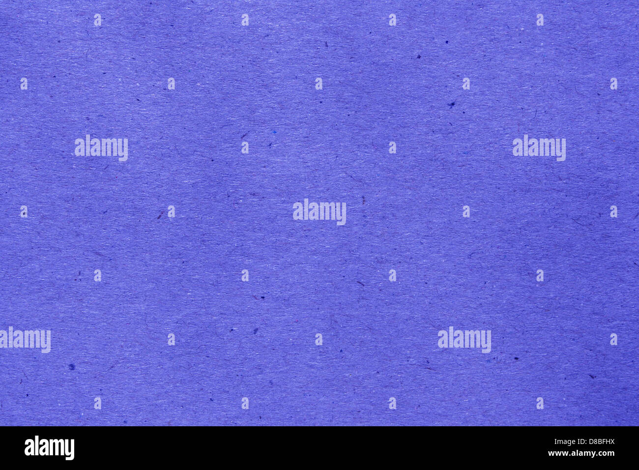 This image shows a close-up of indigo blue paper with small flecks ...
