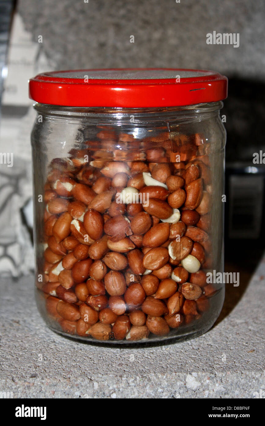 A jar filled with peanuts, showcasing the texture of the nuts and the ...