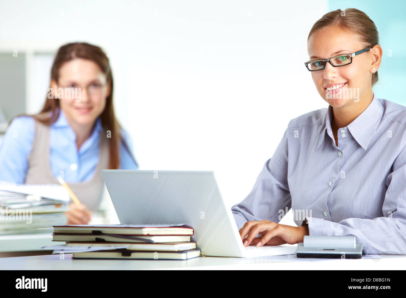 Portrait of pretty secretary looking at camera while working Stock ...