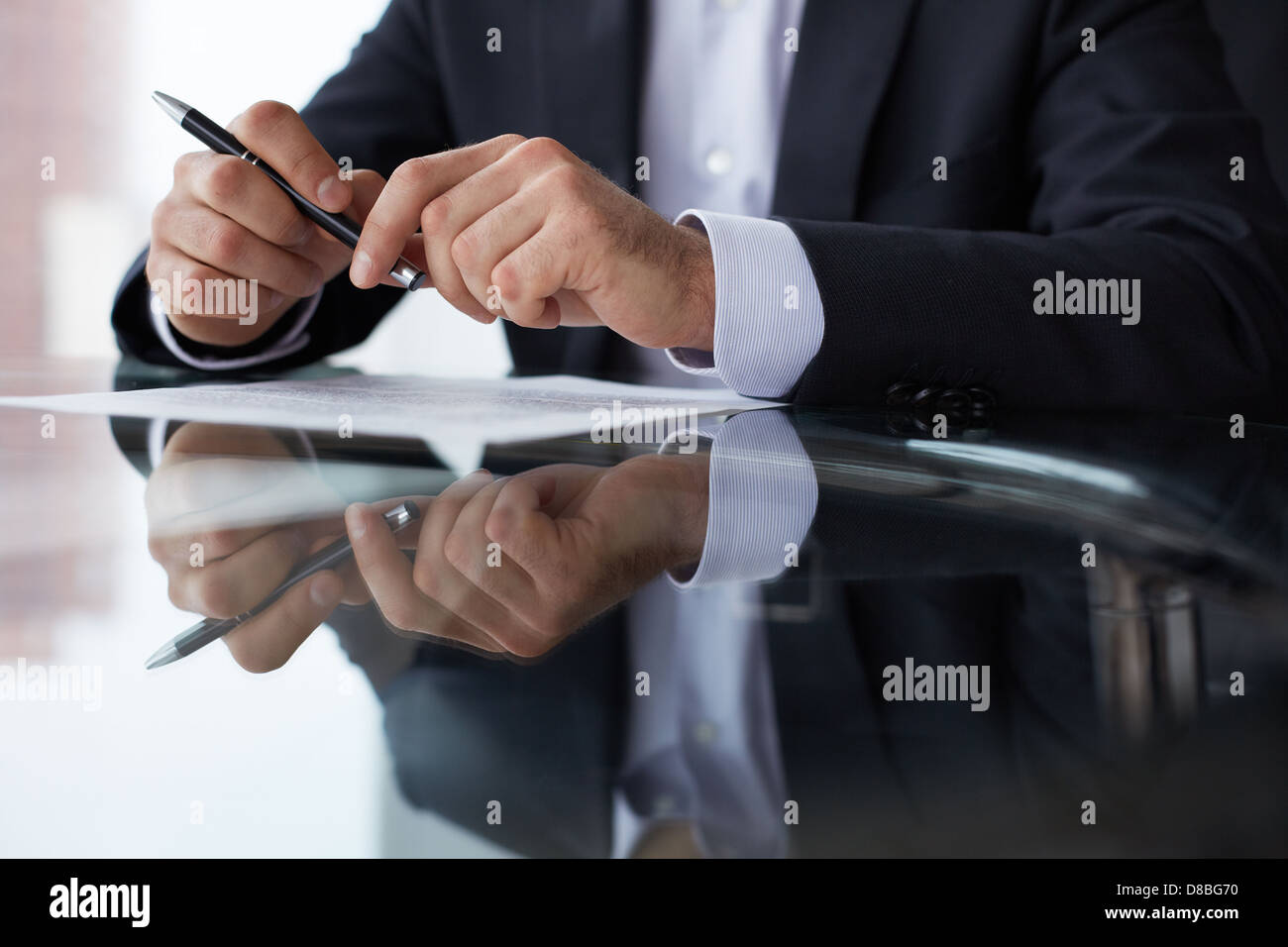 Close-up of male hands with pen over document Stock Photo - Alamy