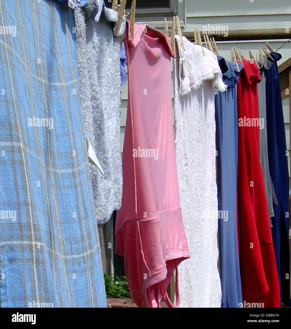 Clothes are drying on a clothesline in an outdoor setting. The image ...
