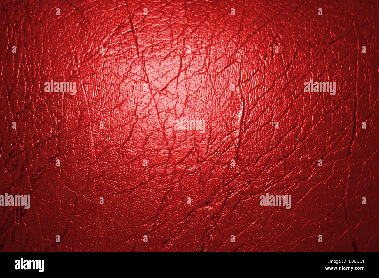 A close-up of a red leather texture, showing the smooth, supple surface ...