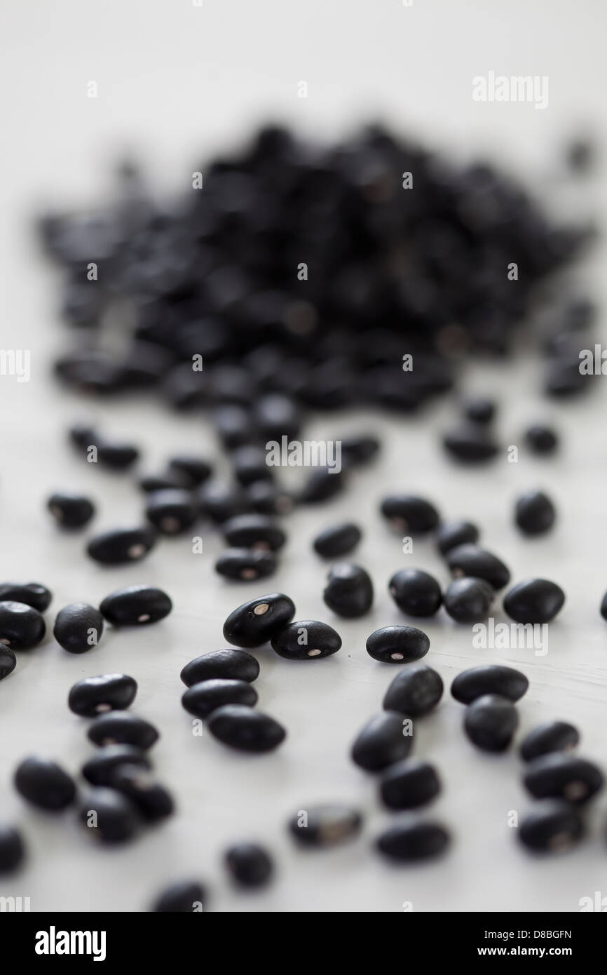 A scattering of black beans on a white wood surface Stock Photo - Alamy