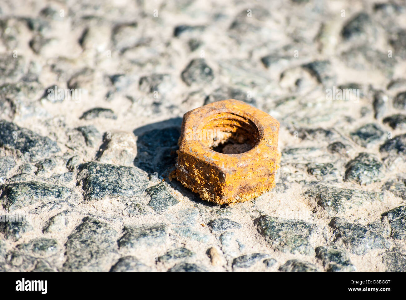 rusty Hex nut on the pavement, brightly lit, macro Stock Photo - Alamy