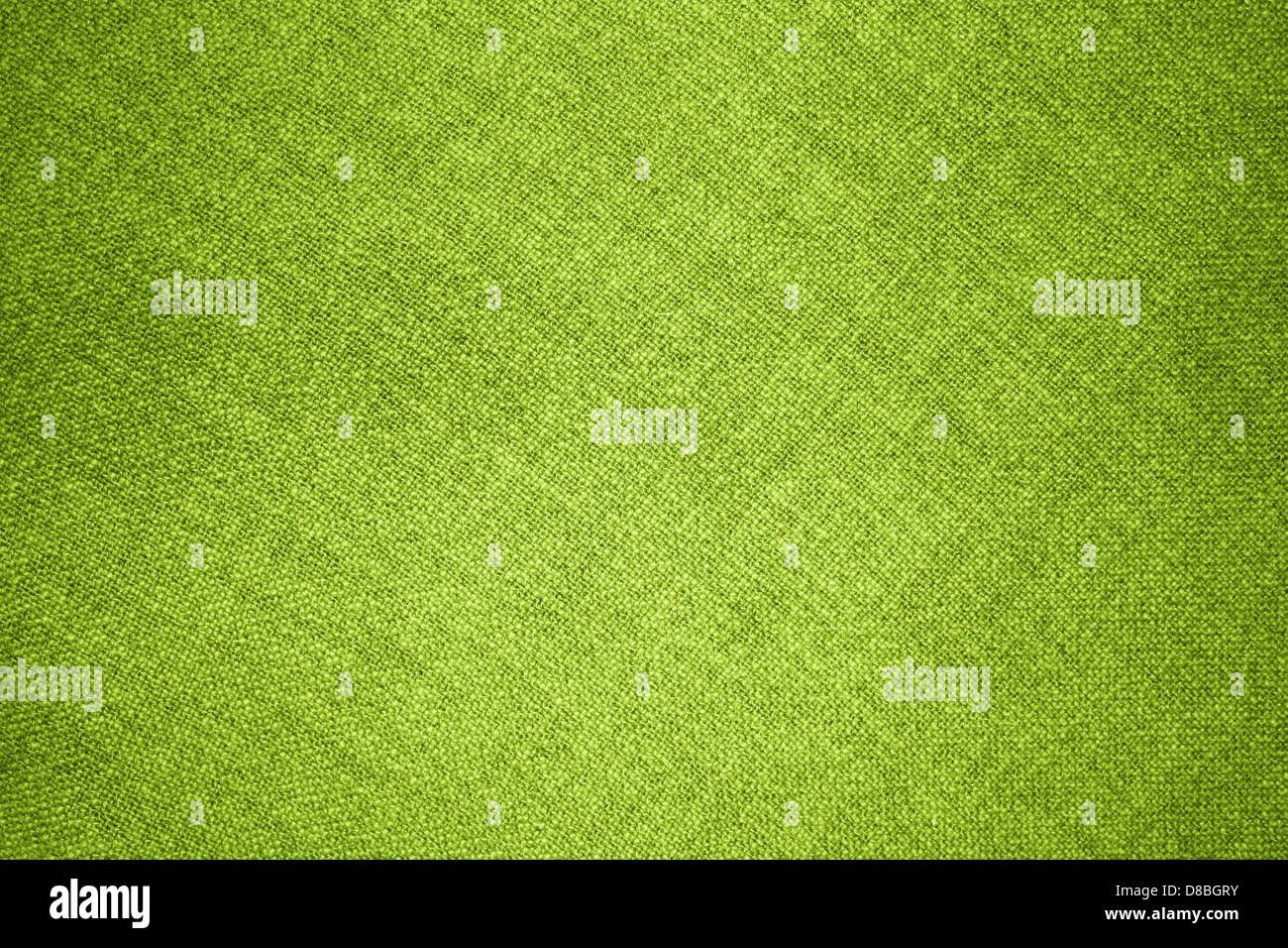 This close-up of lime green fabric showcases a smooth texture, bright ...