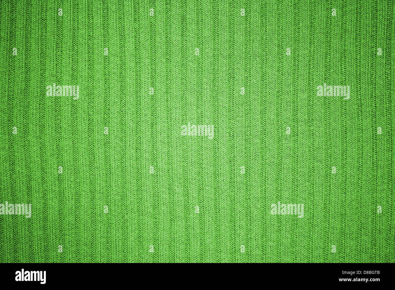 A close-up view of a lime green ribbed knit fabric. The texture ...