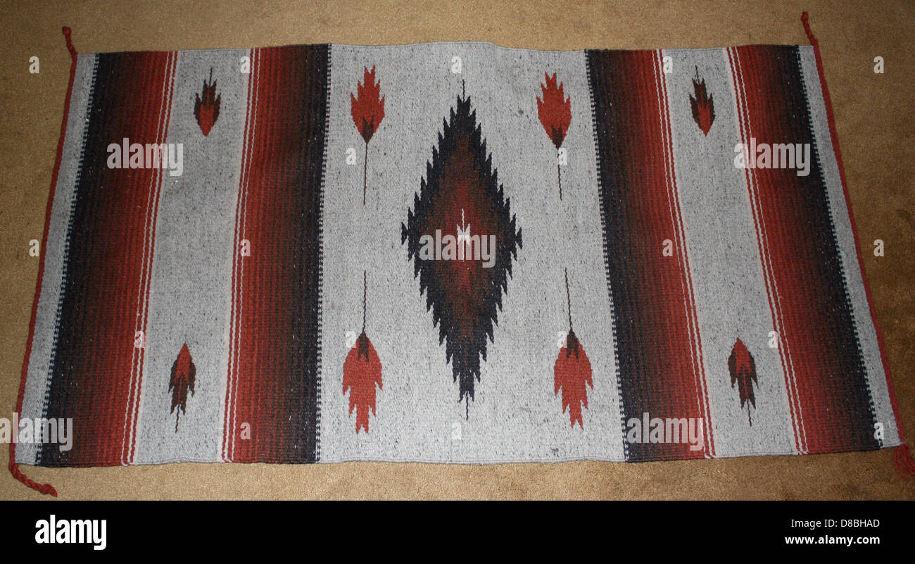 This image shows a traditional Navajo rug, known for its intricate ...