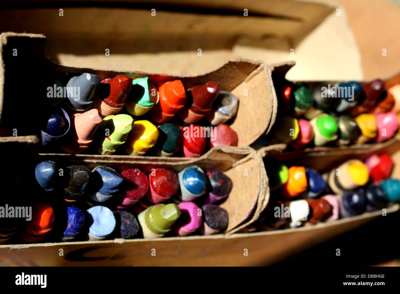 A collection of old, used crayons, each worn and faded from years of ...