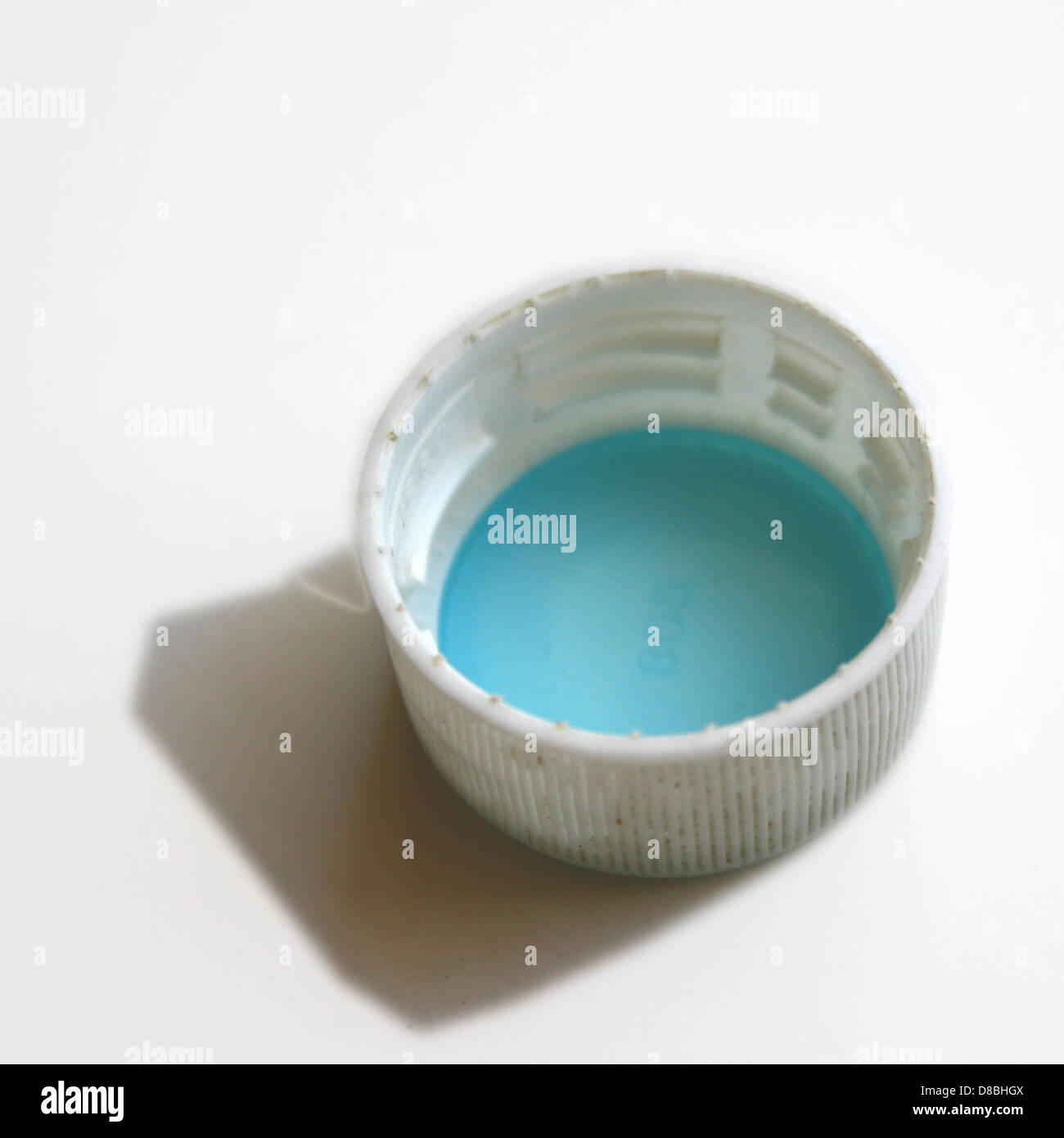 A close-up image of an old plastic bottle cap, showing wear and age ...